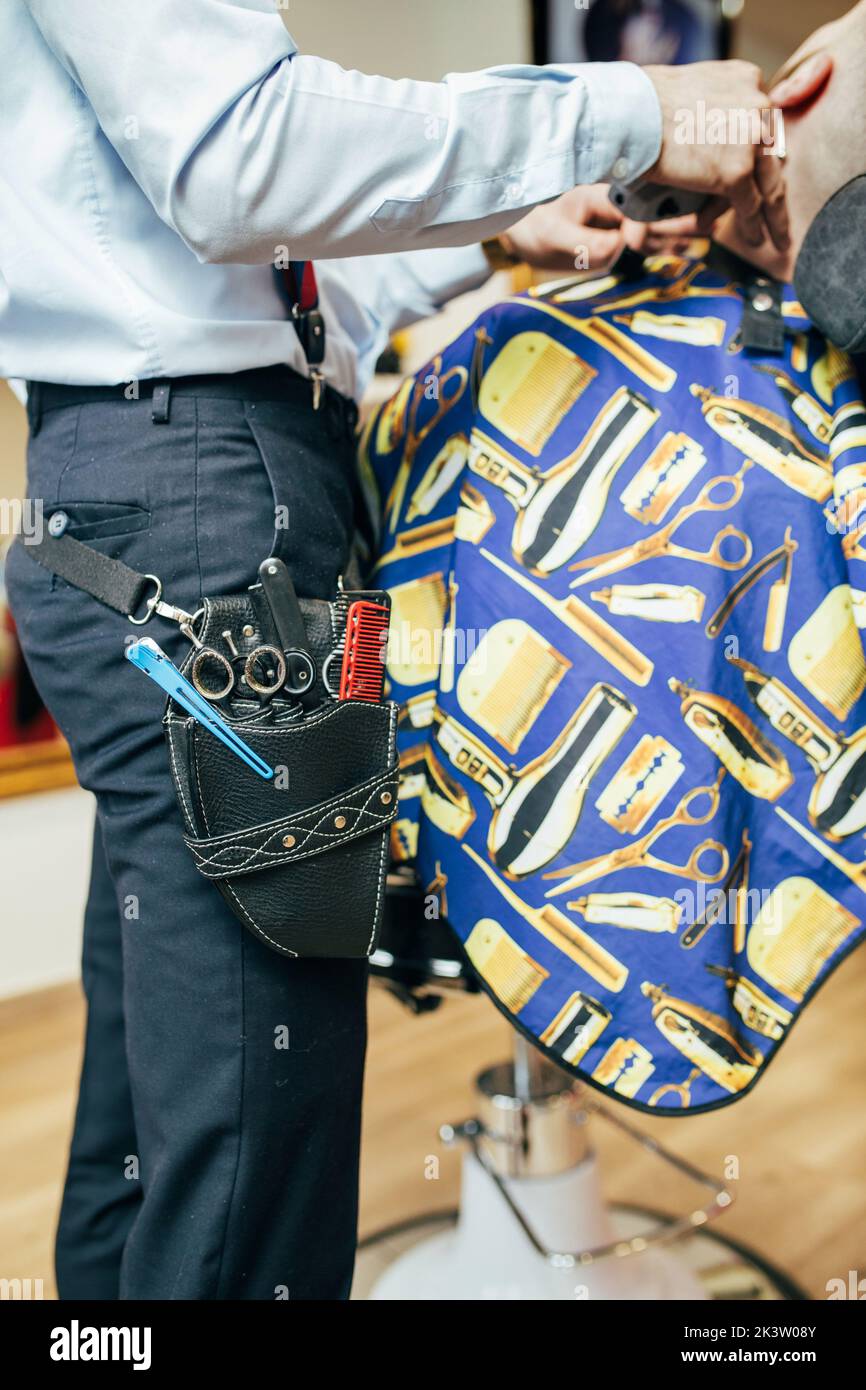 Barber tools in a leg pouch: scissors, razors, combs Stock Photo - Alamy