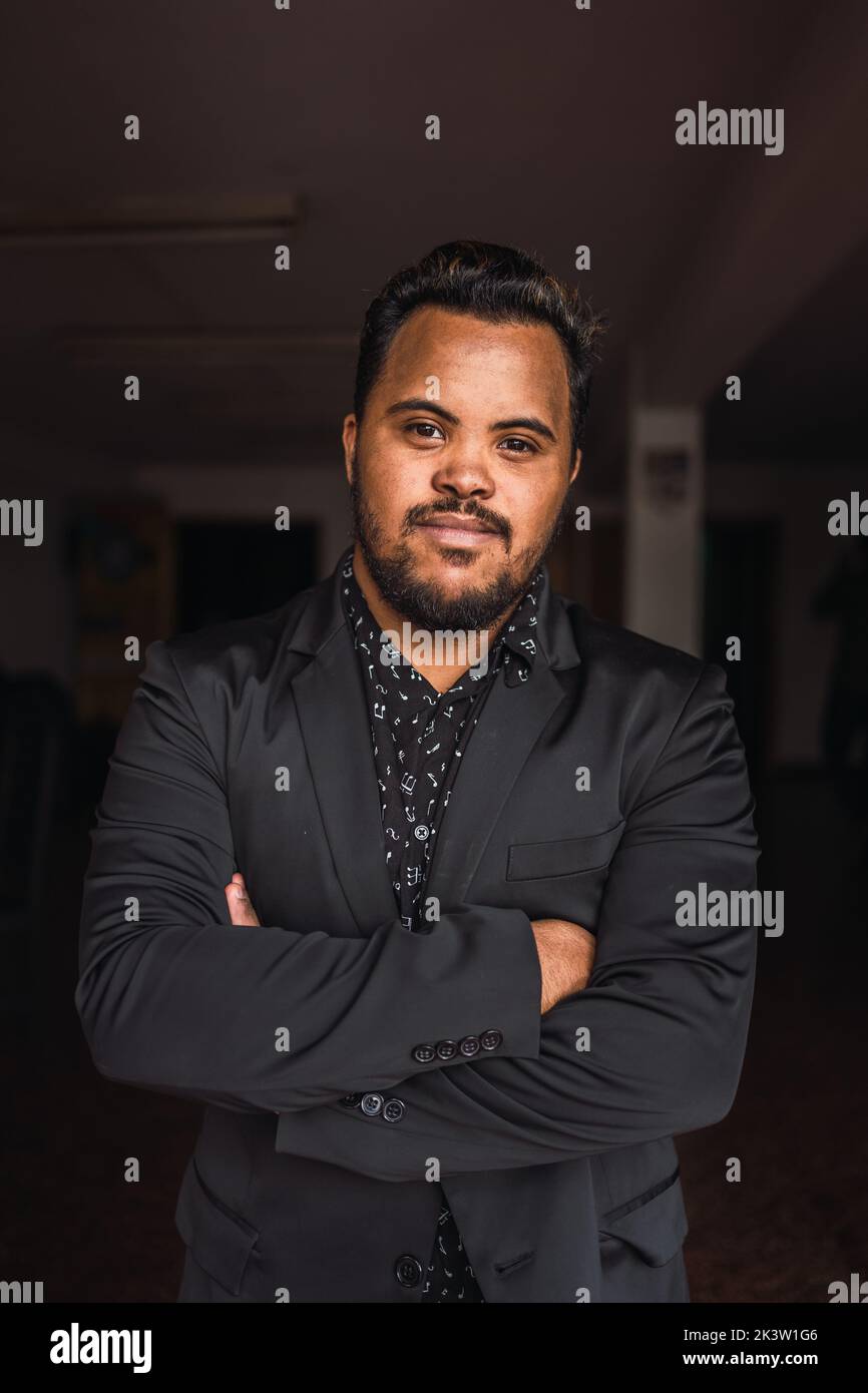 Self assured black male with beard in elegant suit standing looking at ...