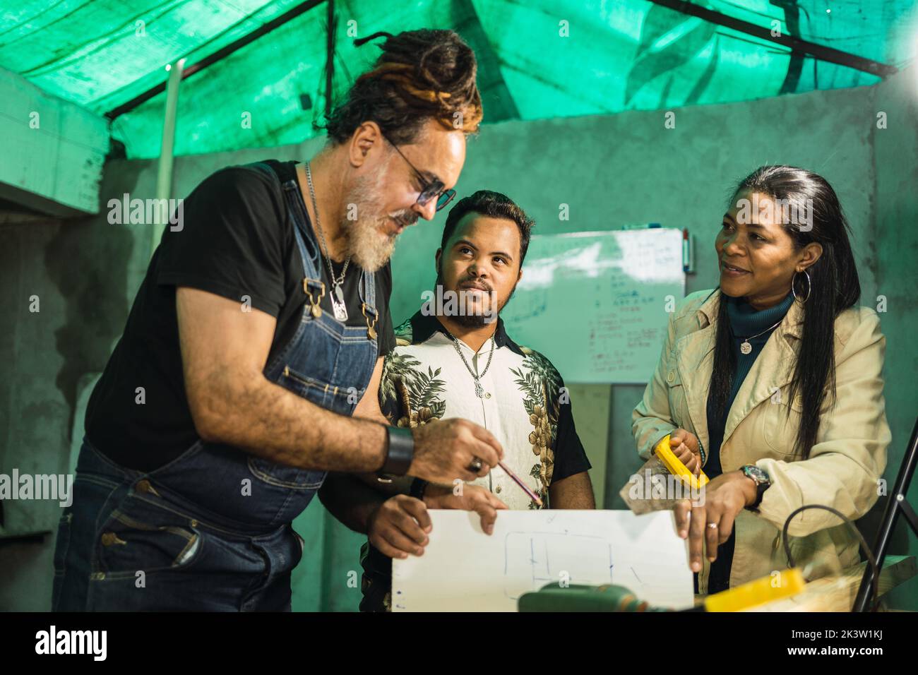 Serious males and woman with papers standing at table with wooden board ...