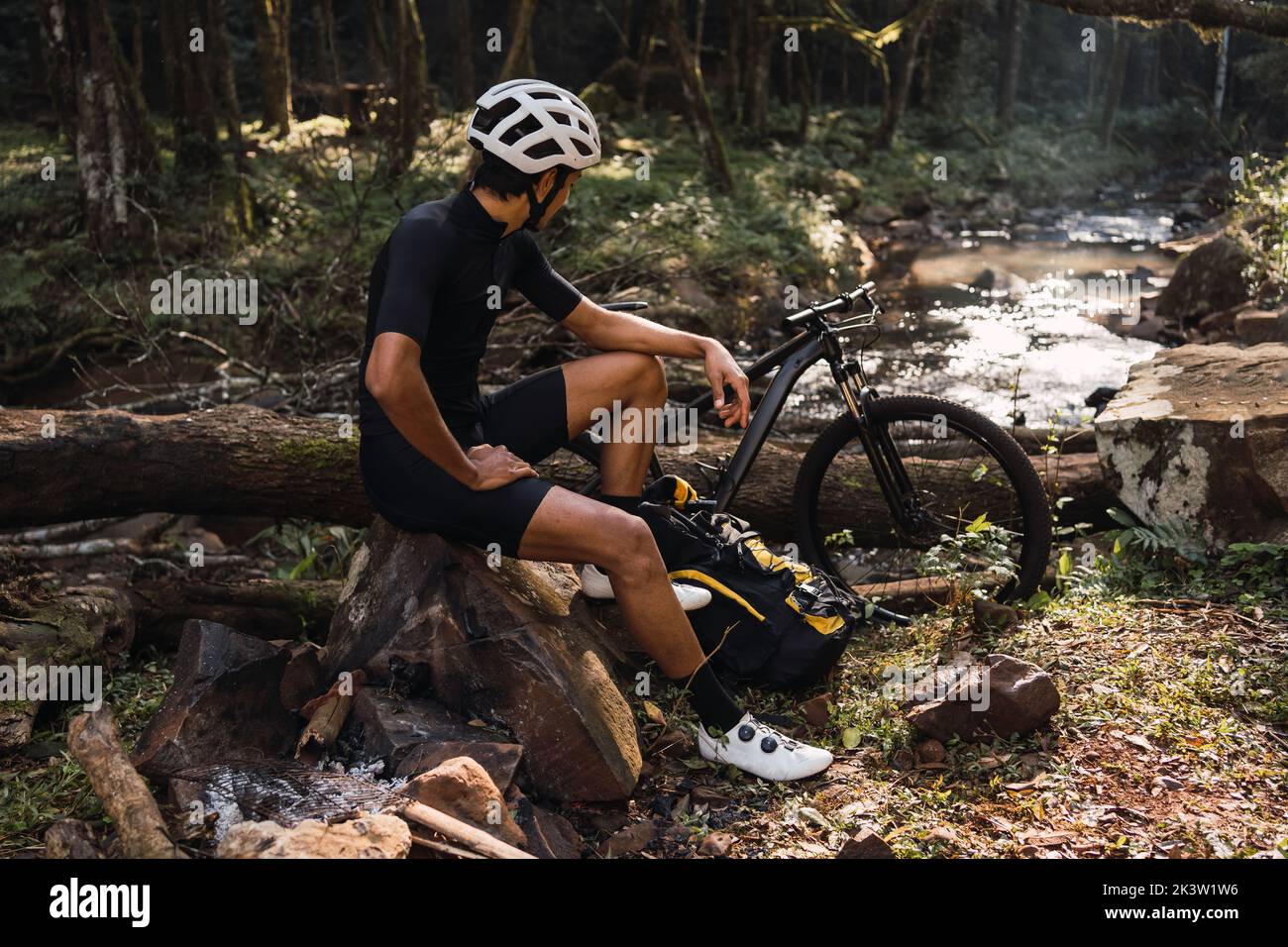 Side view of anonymous male biker in helmet and sportswear admiring ...