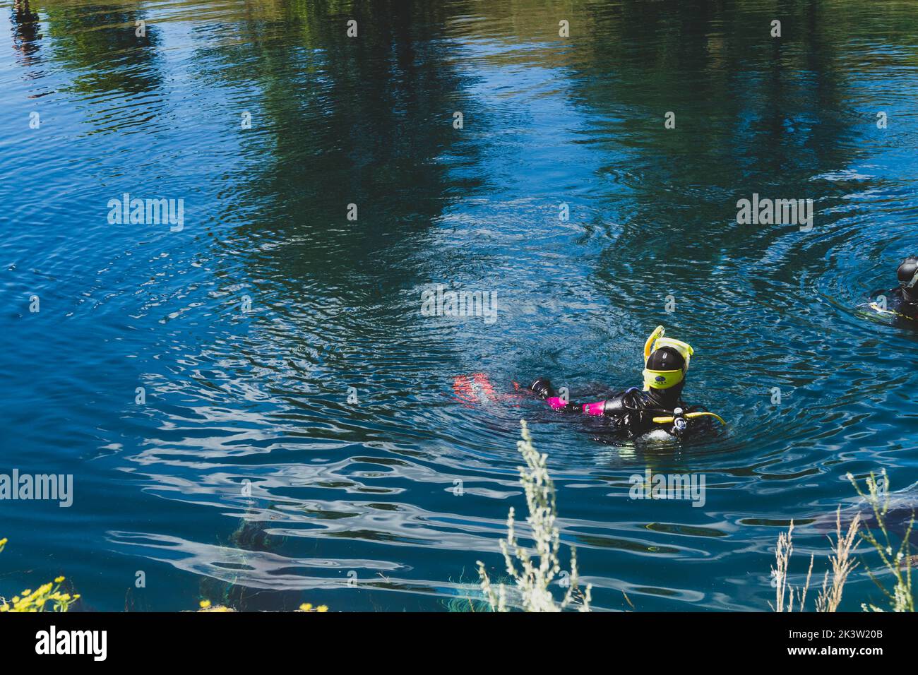 Divers in water. Study of river bottom. Search for missing people ...