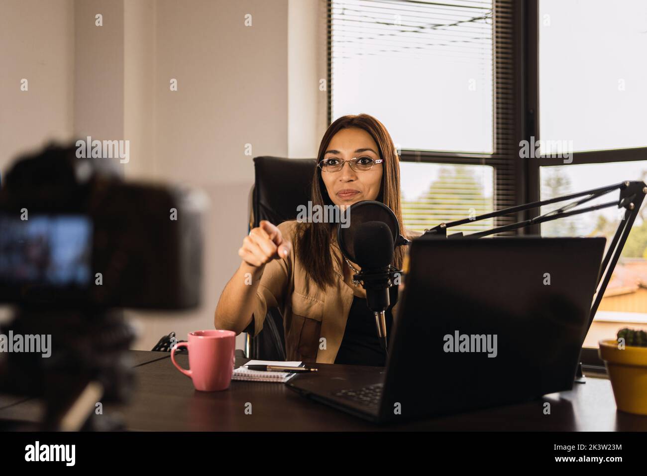 Happy influencer using microphone hi-res stock photography and images ...