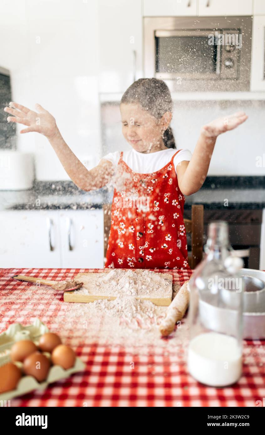 Child having fun with flour during cooking process in house Stock Photo ...