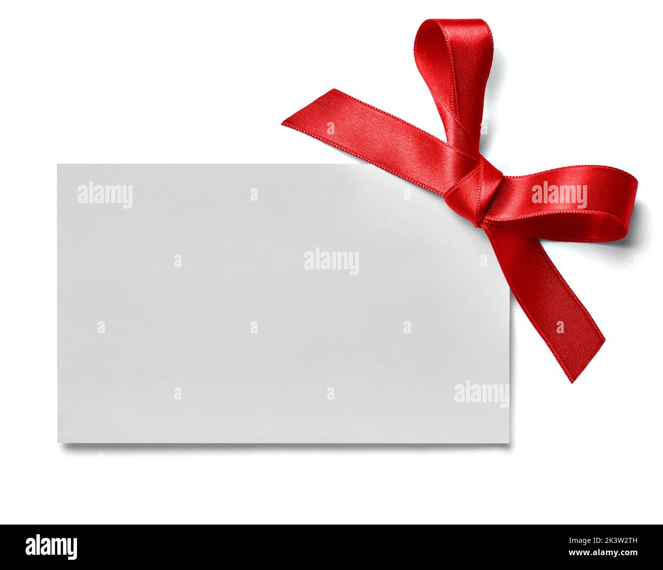 close up of a greeting card note with red ribbon on white background ...