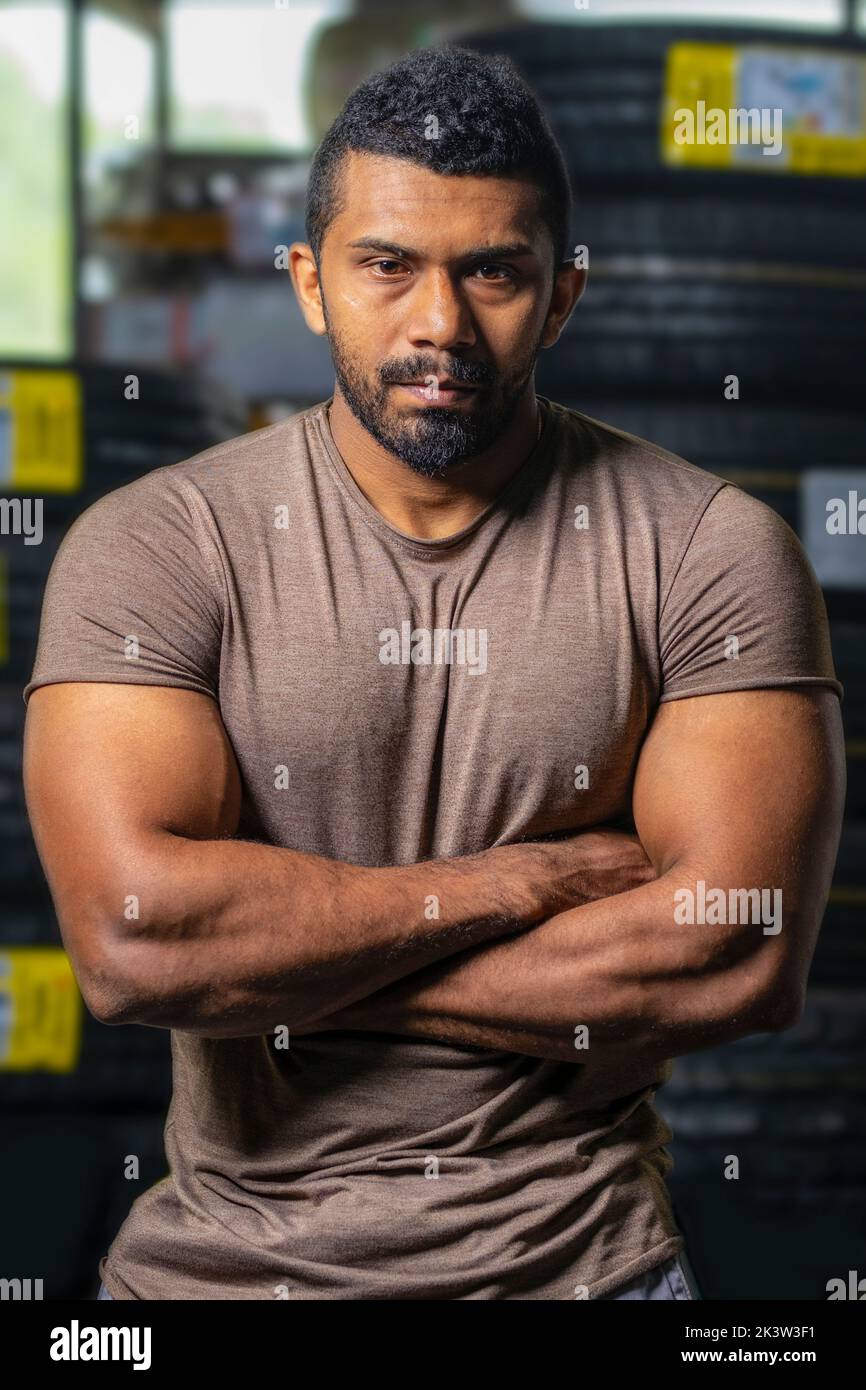 A vertical portrait of brown athletic bodybuilder with muscular body ...
