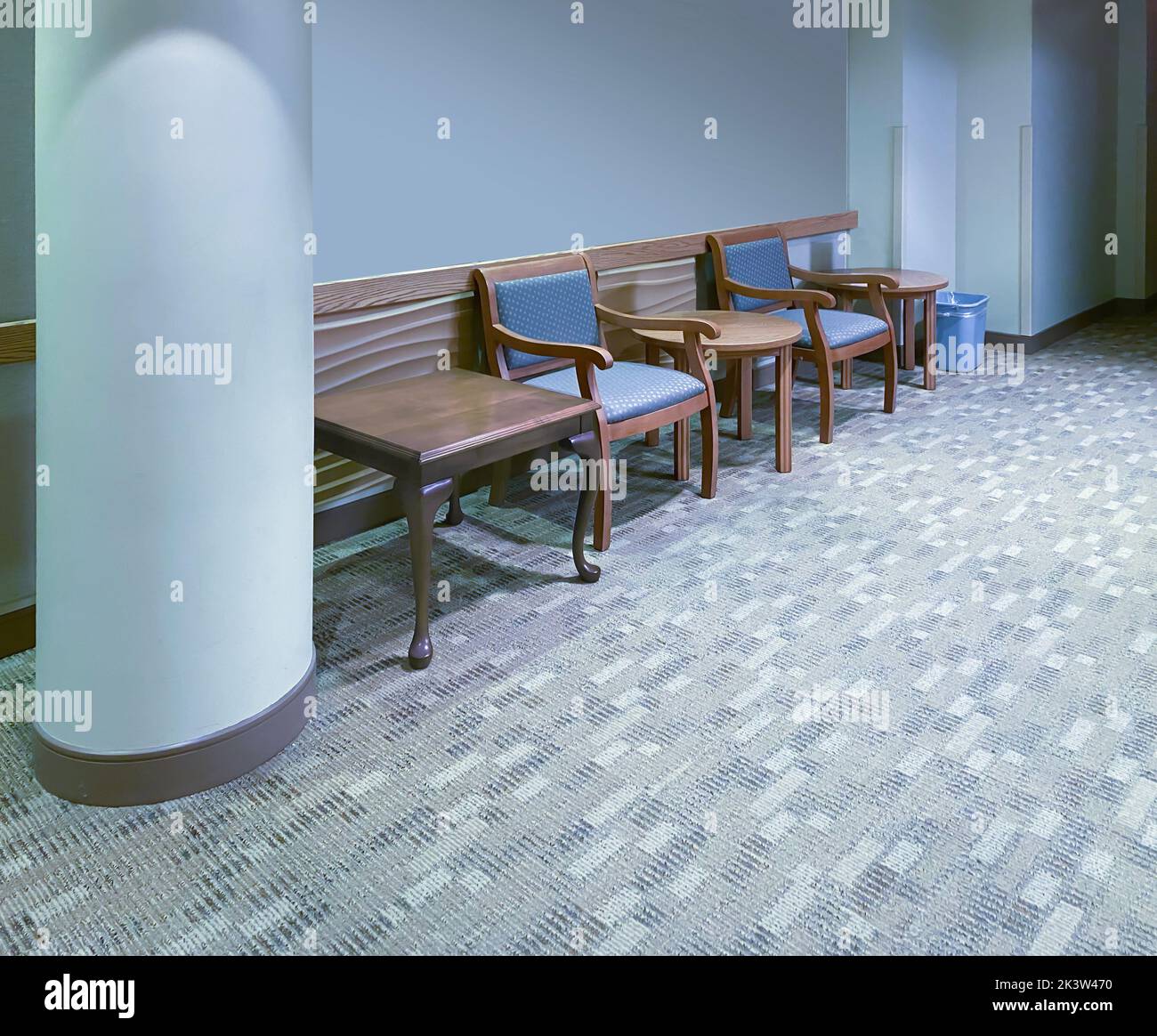 Waiting area room chairs indoors with column Stock Photo - Alamy