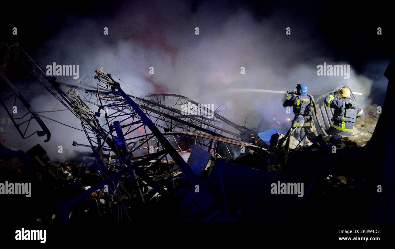 Fighting fires after a rocket attack by Russian troops in Kharkiv ...