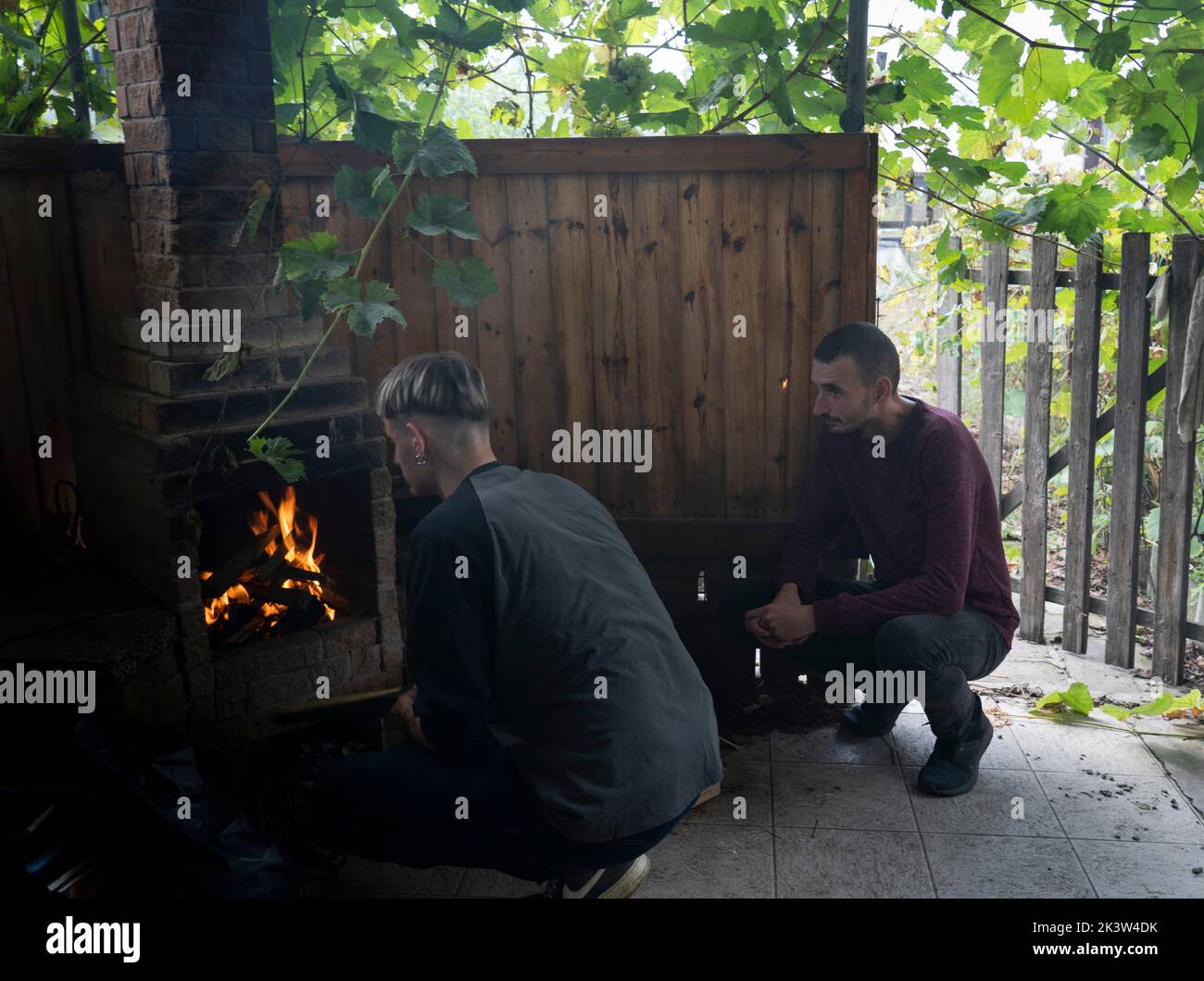 Residents of Izyum, Illia, 26 (L) and Igor, 27 (R) seen starting a fire ...