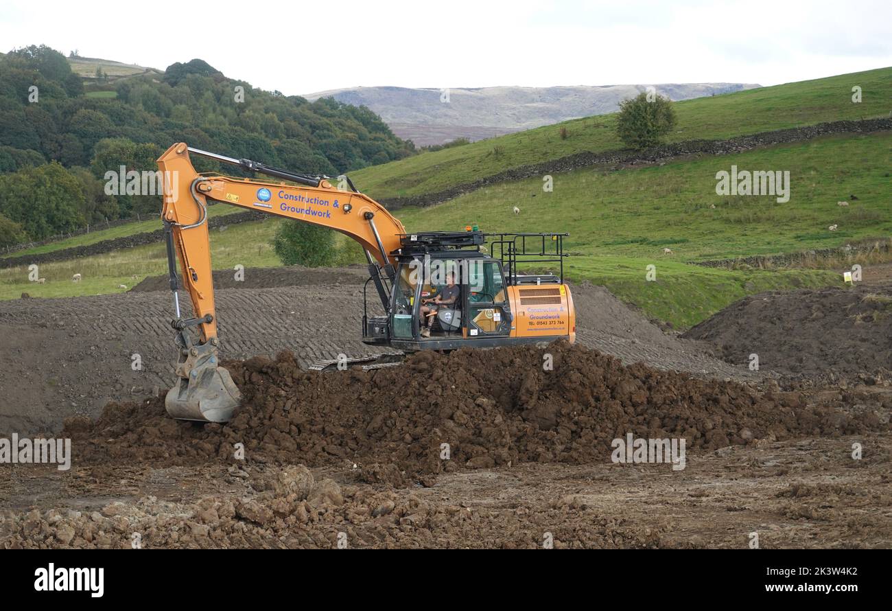A digger excavating the ground in preparation for building new houses ...