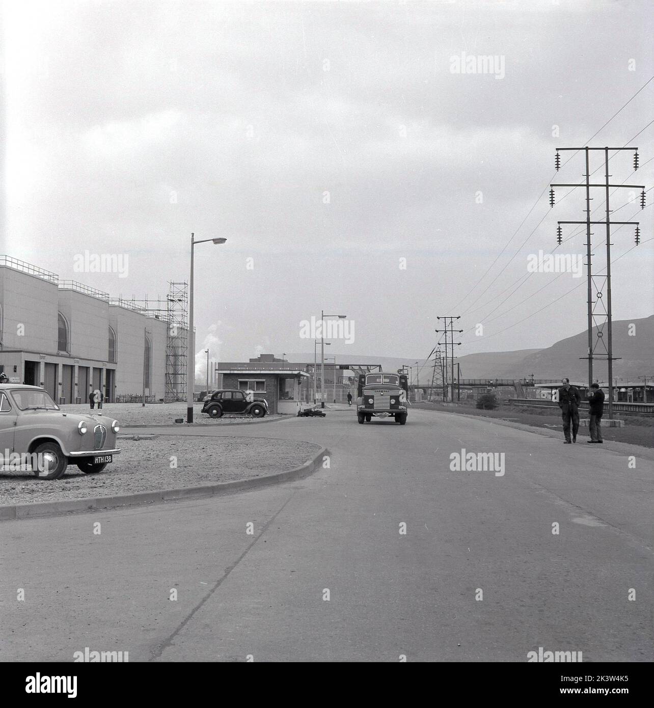 1950s, historical, cars of the era at a factory road at the Steel ...