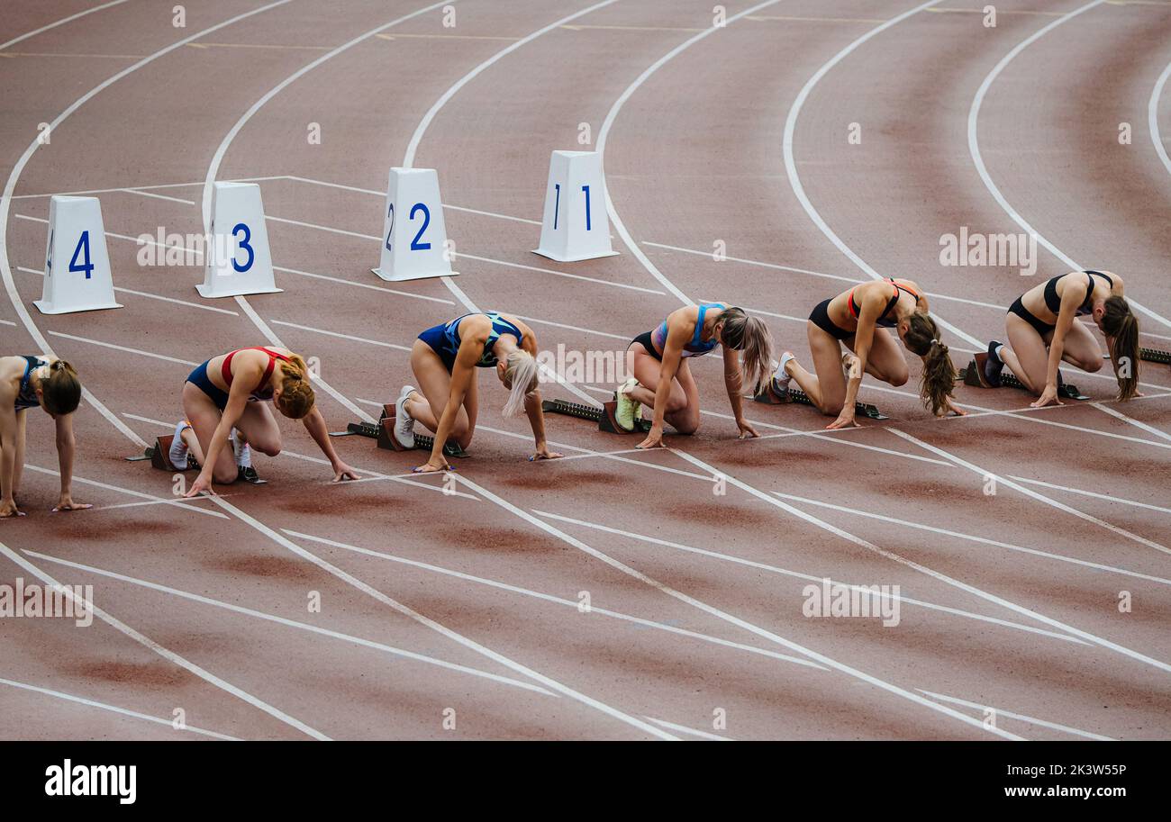 race female athletes runners start at 100 meters Stock Photo - Alamy