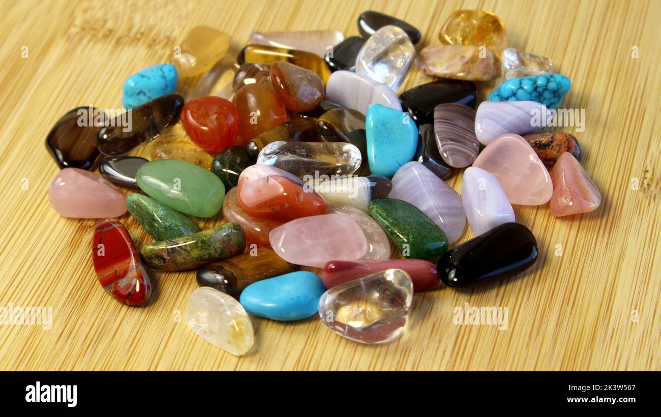 Collection Of Semi-Precious Gemstones on white textured board ...