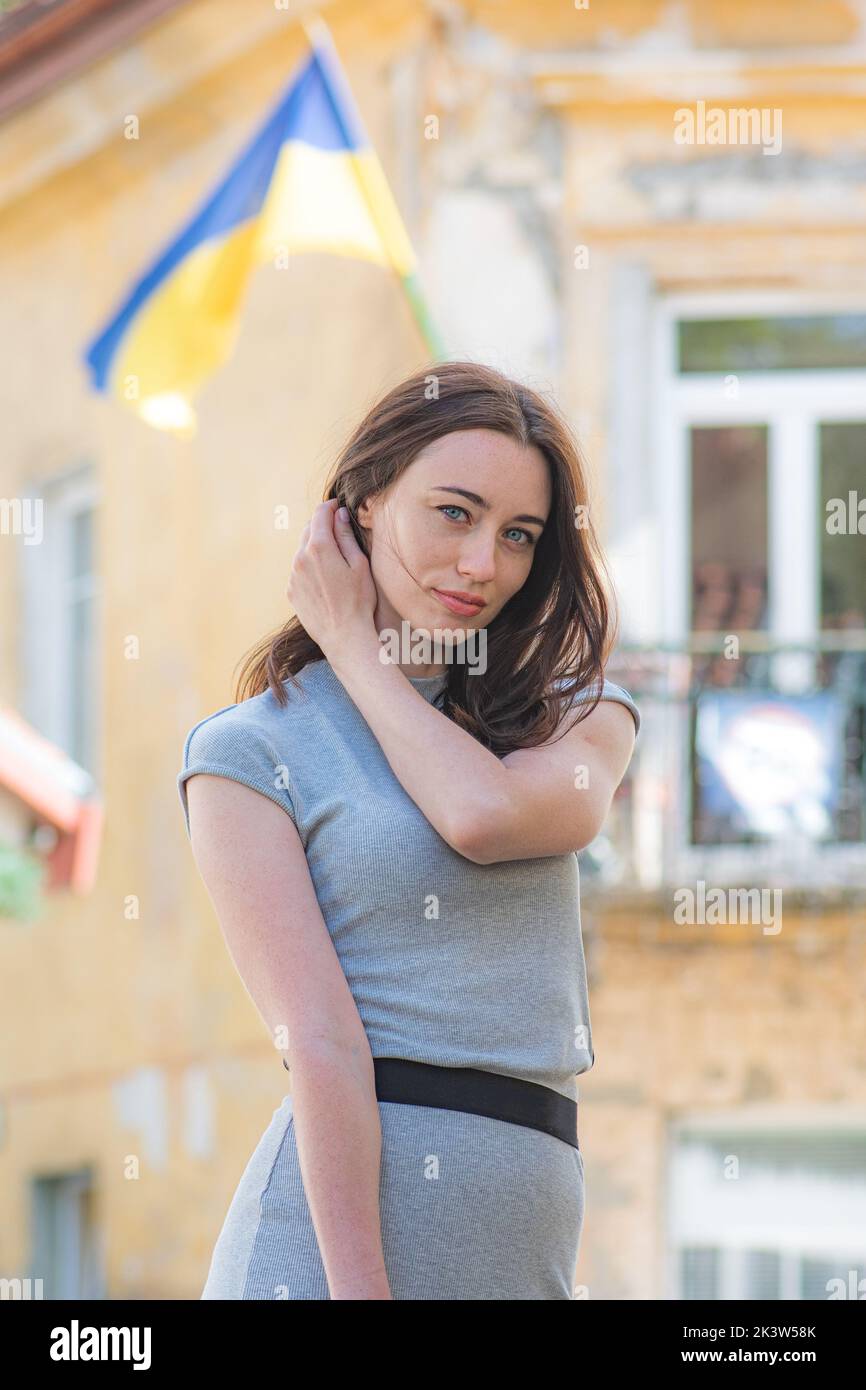 Beautiful Ukrainian girl with red hair and blue eyes in a short grey ...