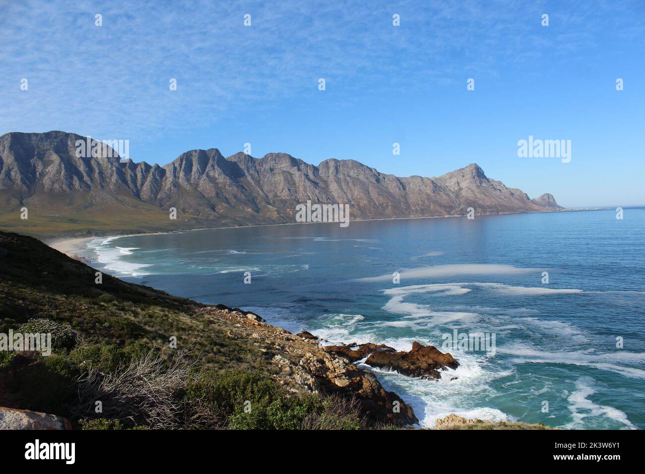 Dramatic combination of sandy beach and mountains in the coastline of ...