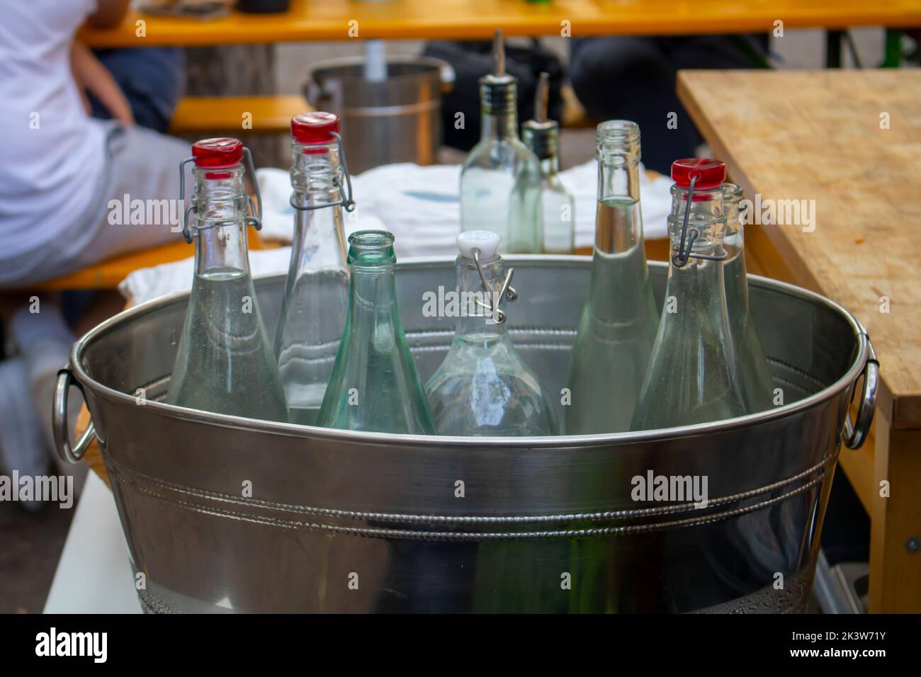 chilled water galss bottle in big stainles steel bowl Stock Photo - Alamy