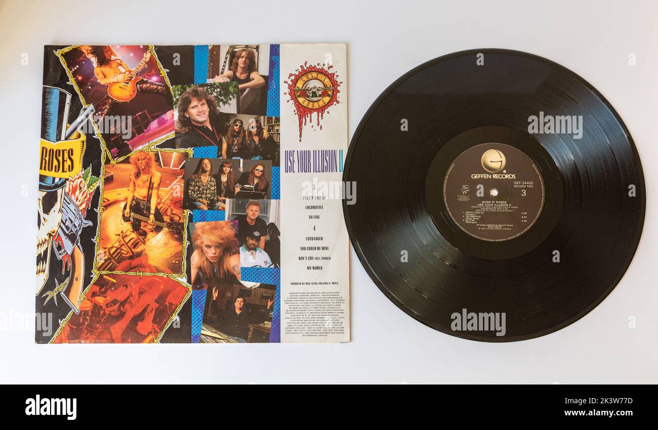 A top view of the cover of the Guns N Roses vinyl and the CD on a white ...