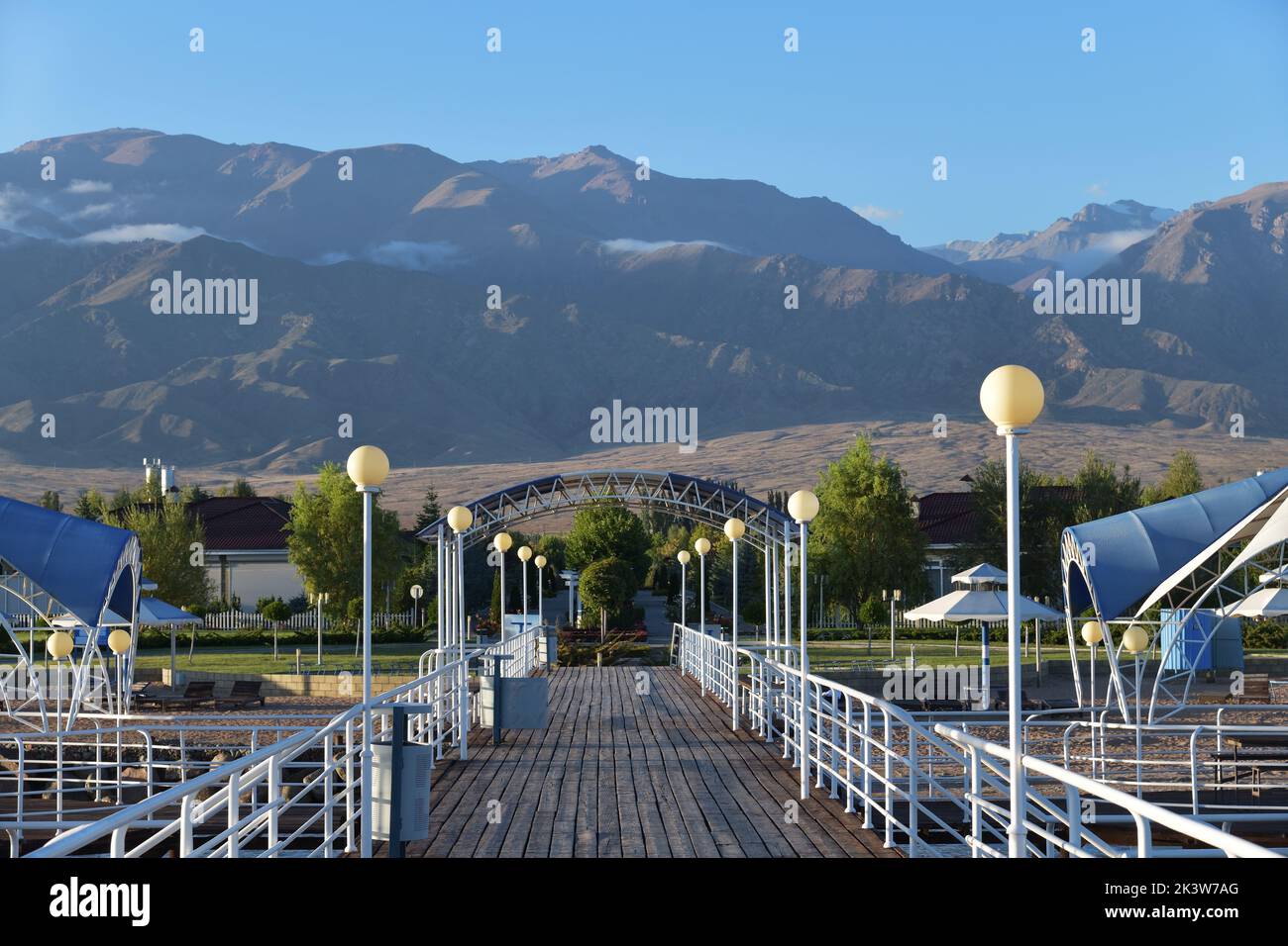 Resort on north shore of the Lake Issyk-Kul and view on high mountain ...