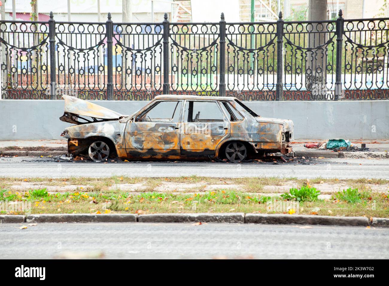 Burnt car body on the street. The car after the fire. Burned out car on ...