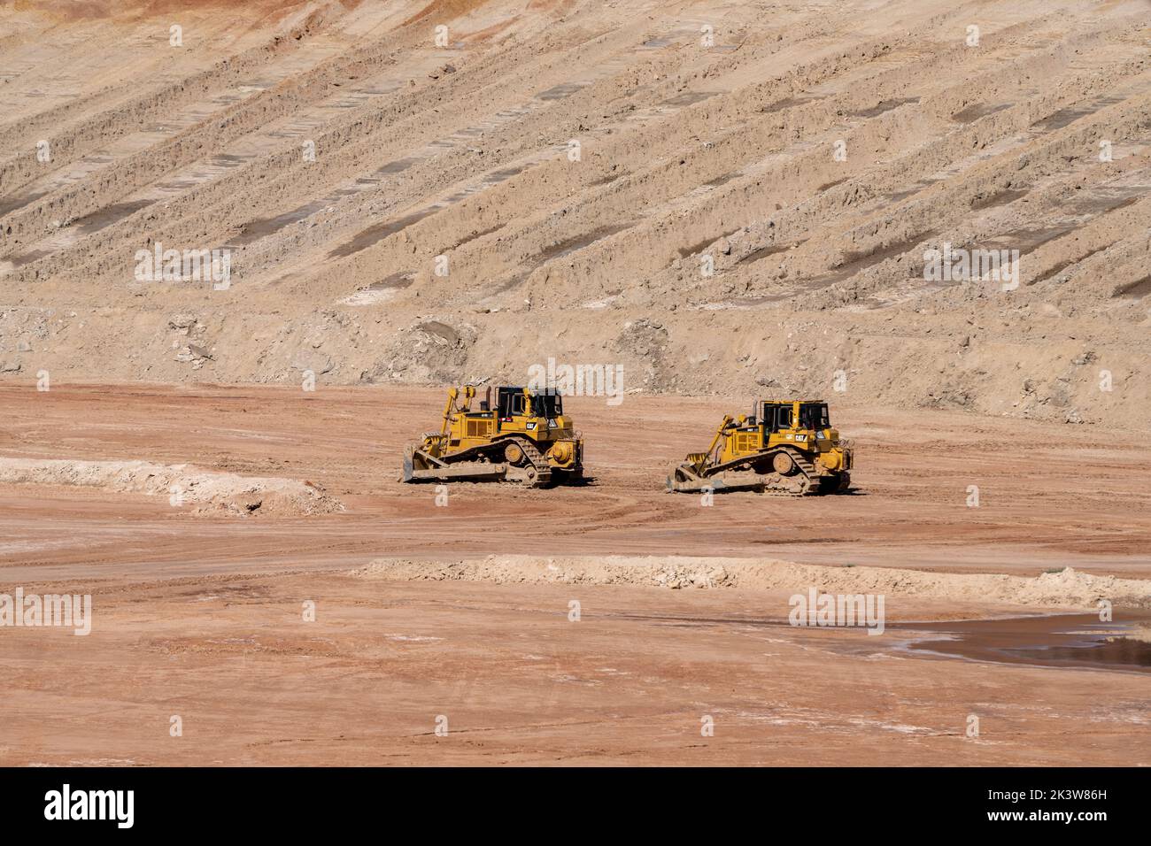 Heavy earth-moving equipment in the uranium tailings pile at the Moab ...