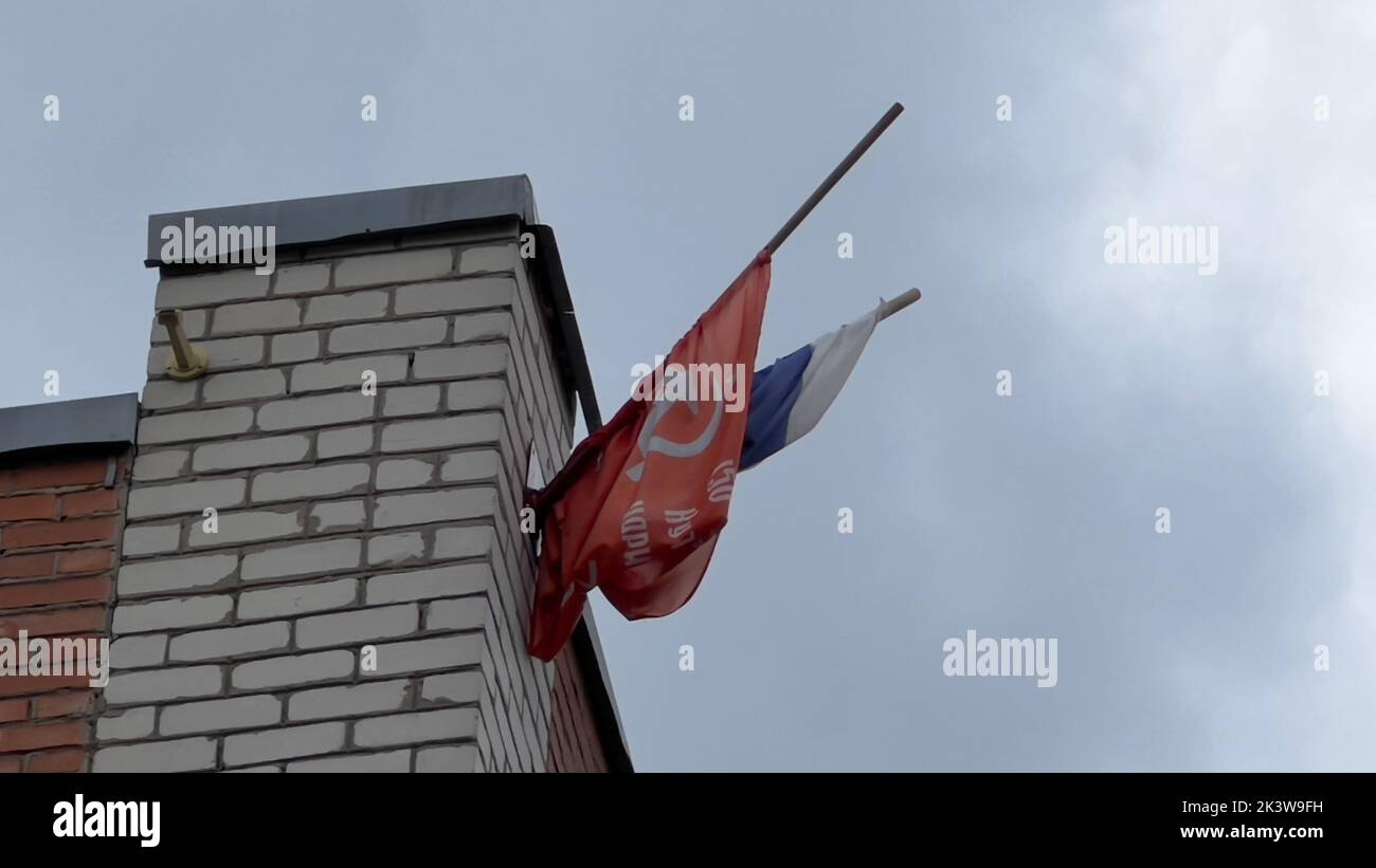 Flags of Russia and Soviet Union on one of the buildings in Kupiansk ...