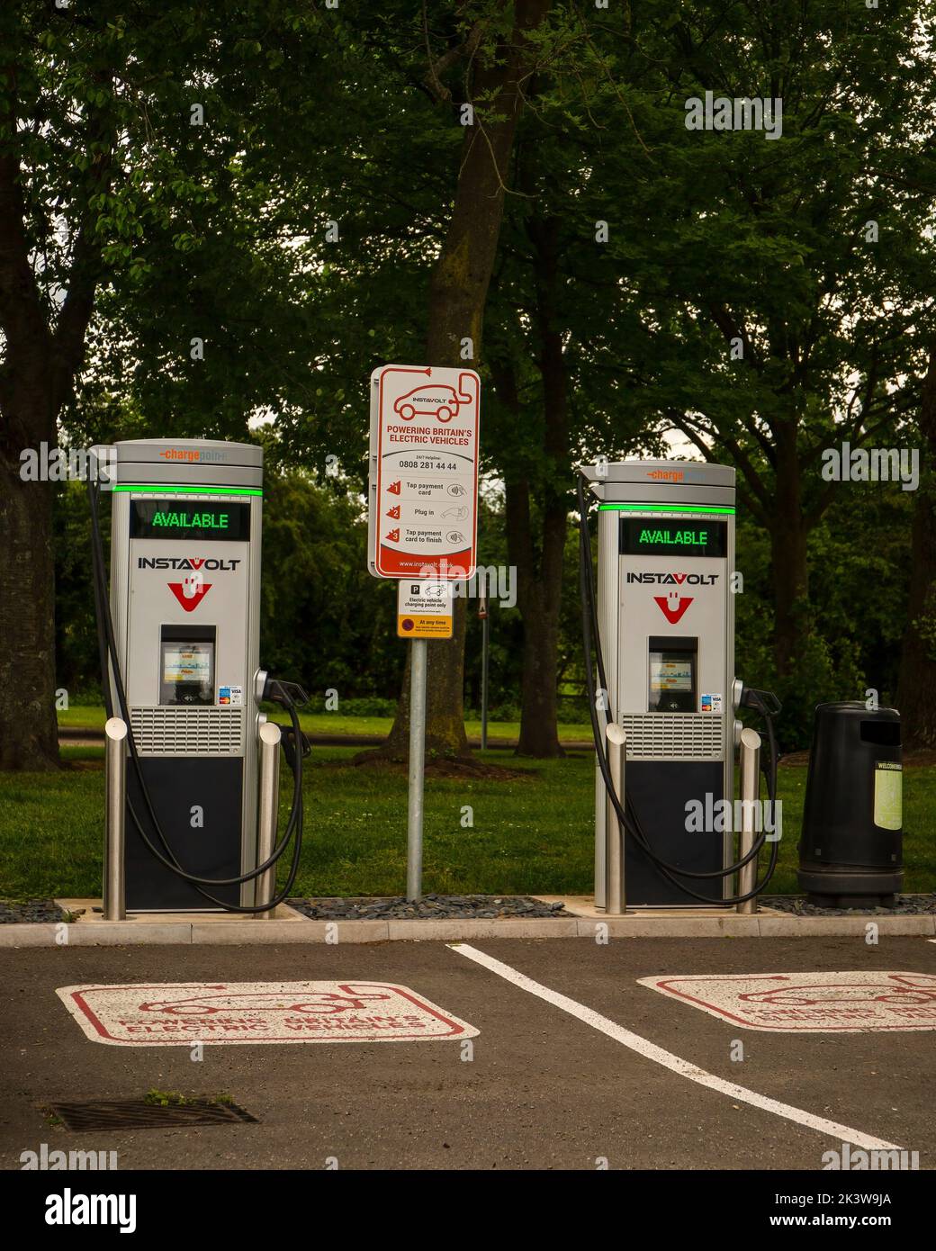 An Instavolt electric vehicle charging station with two spaces available with trees around Stock ...