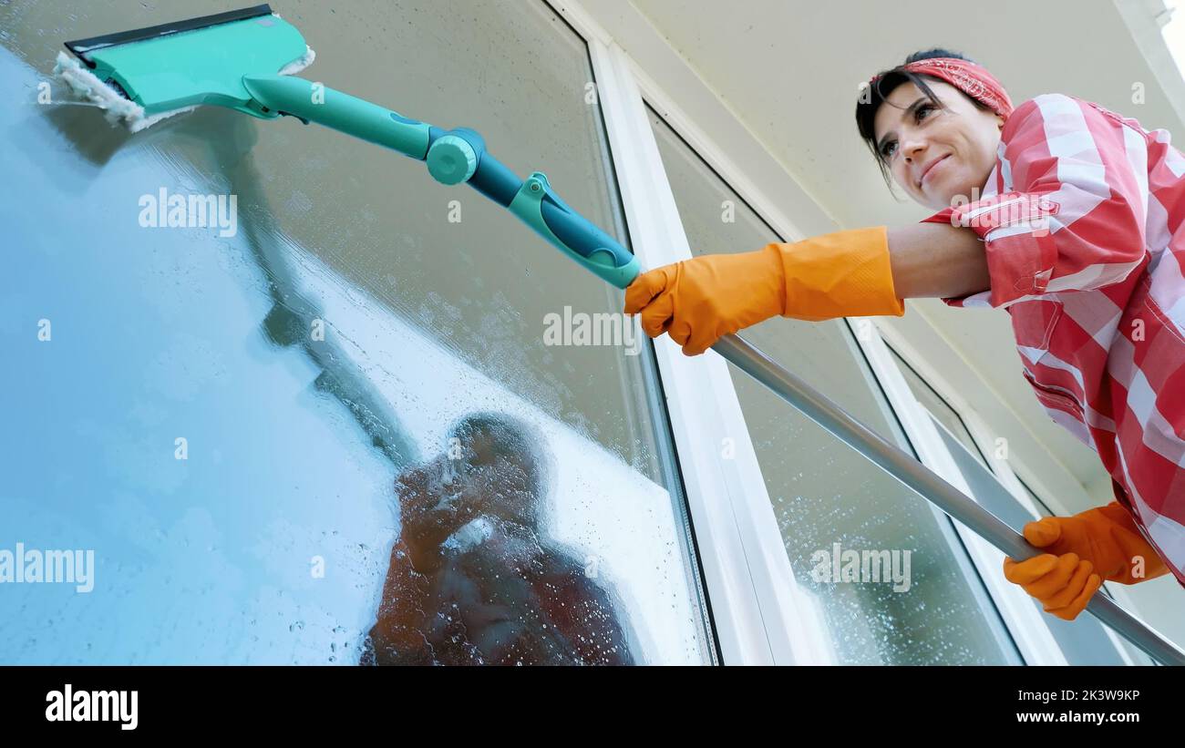 in the window glass is reflected smiling Caucasian Beautiful woman, in ...