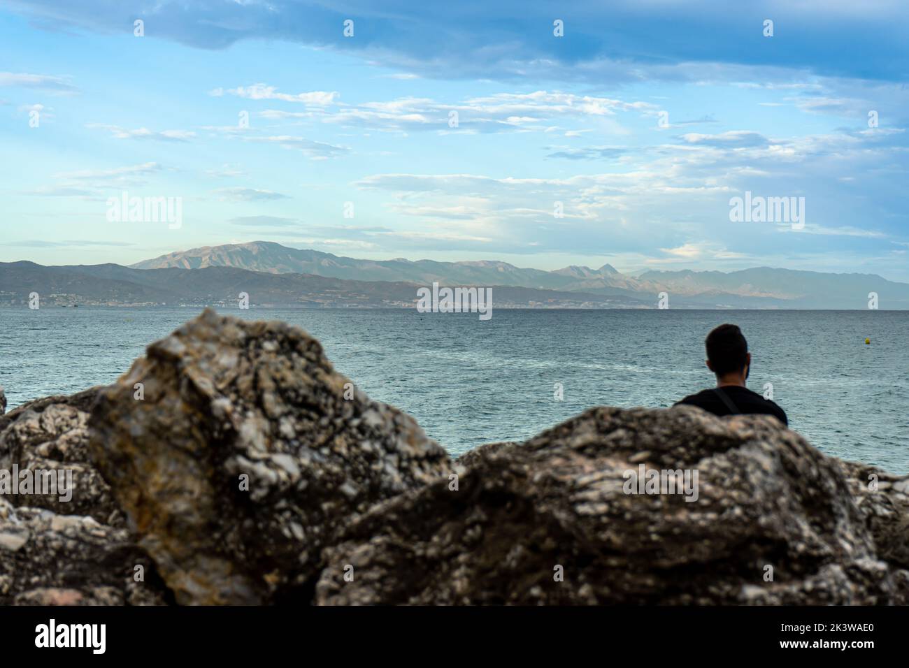 Man relaxing on sunset sky over Mediterranean sea, Costa del Sol, Spain ...
