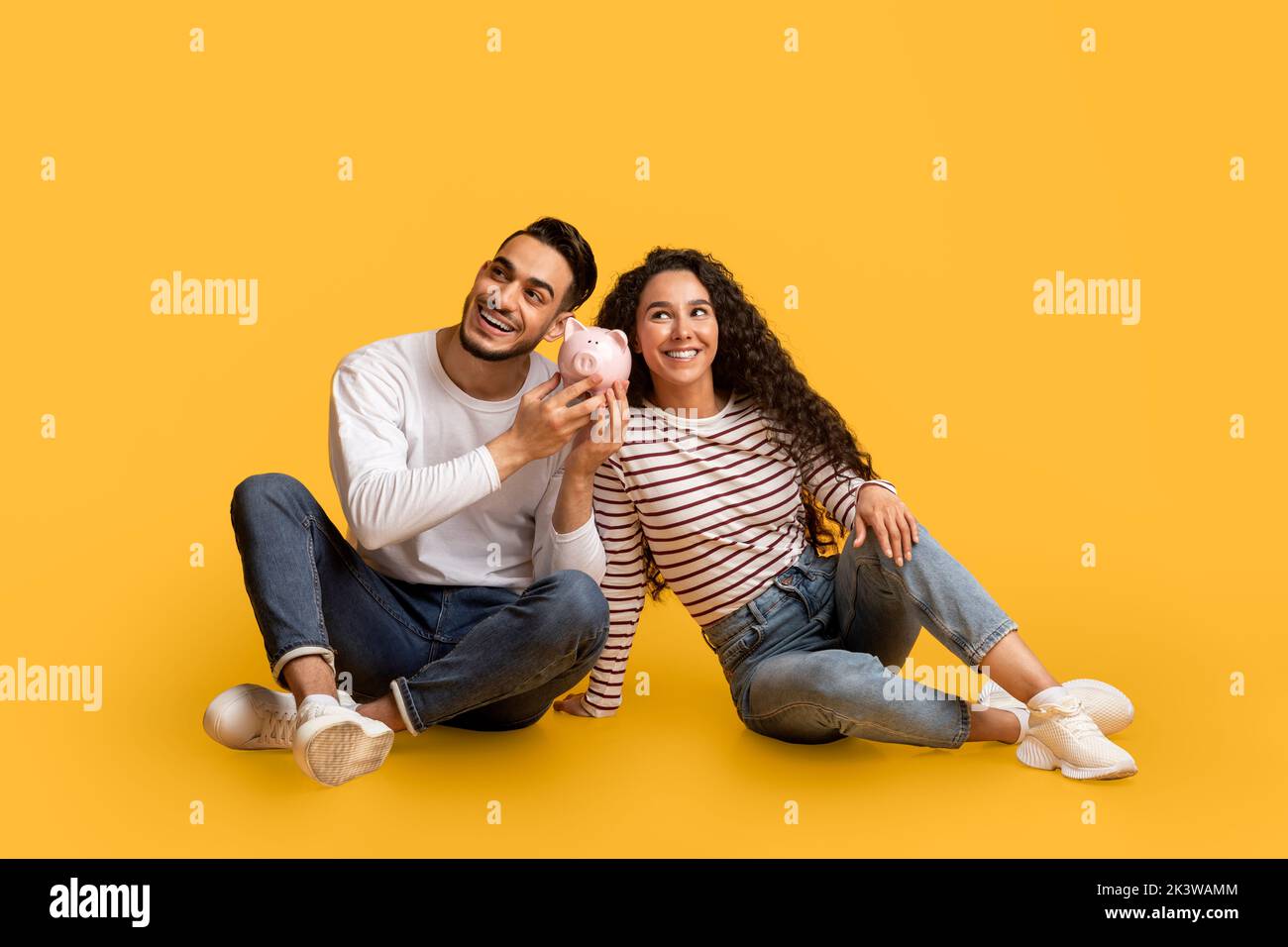 Economy Concept. Happy Young Arab Couple With Piggy Bank In Hands Stock ...