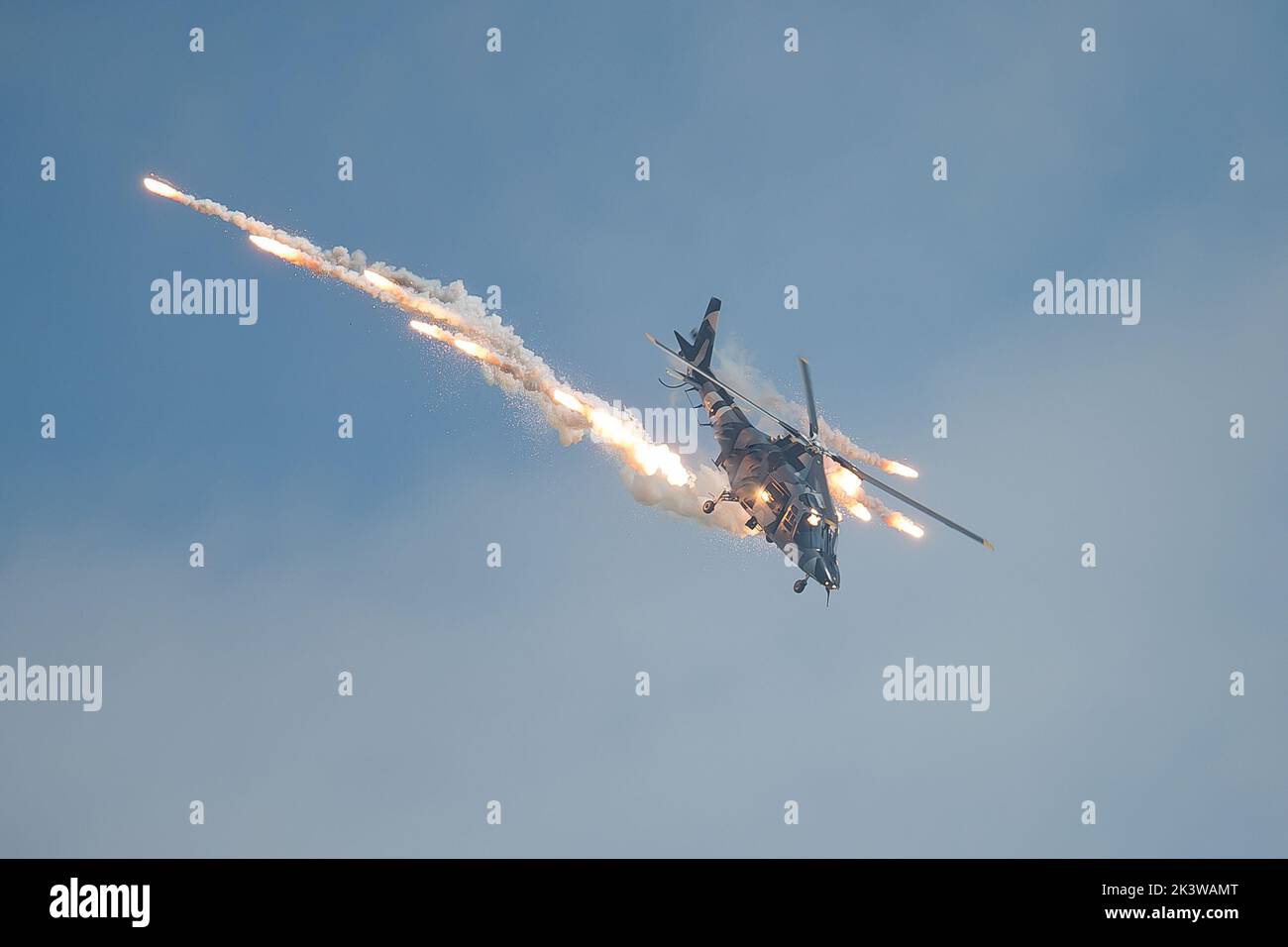 Close-up of a modern combat helicopter ejecting flares decoys to defend ...