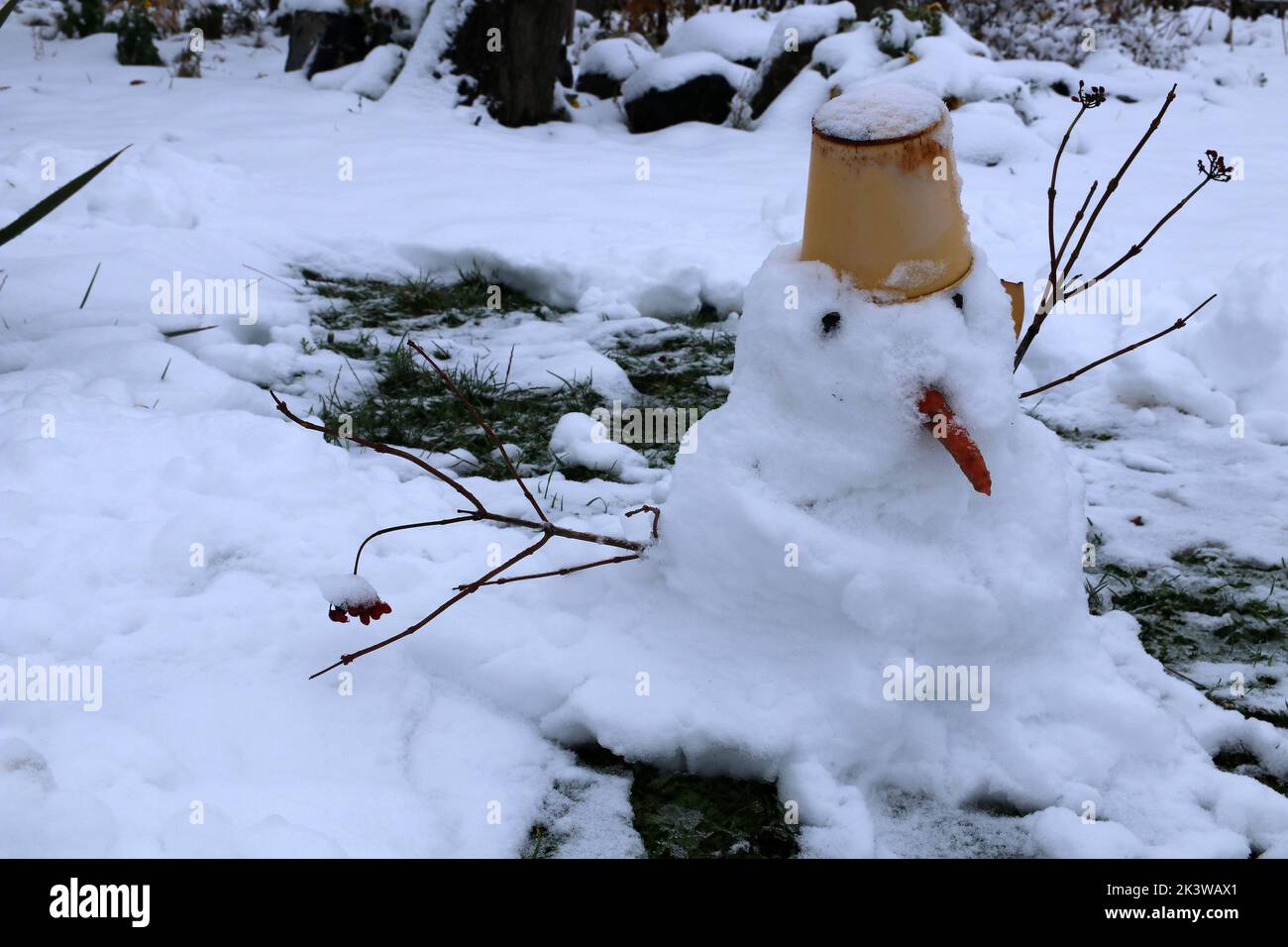 The snowman began to melt due to warm weather Stock Photo - Alamy