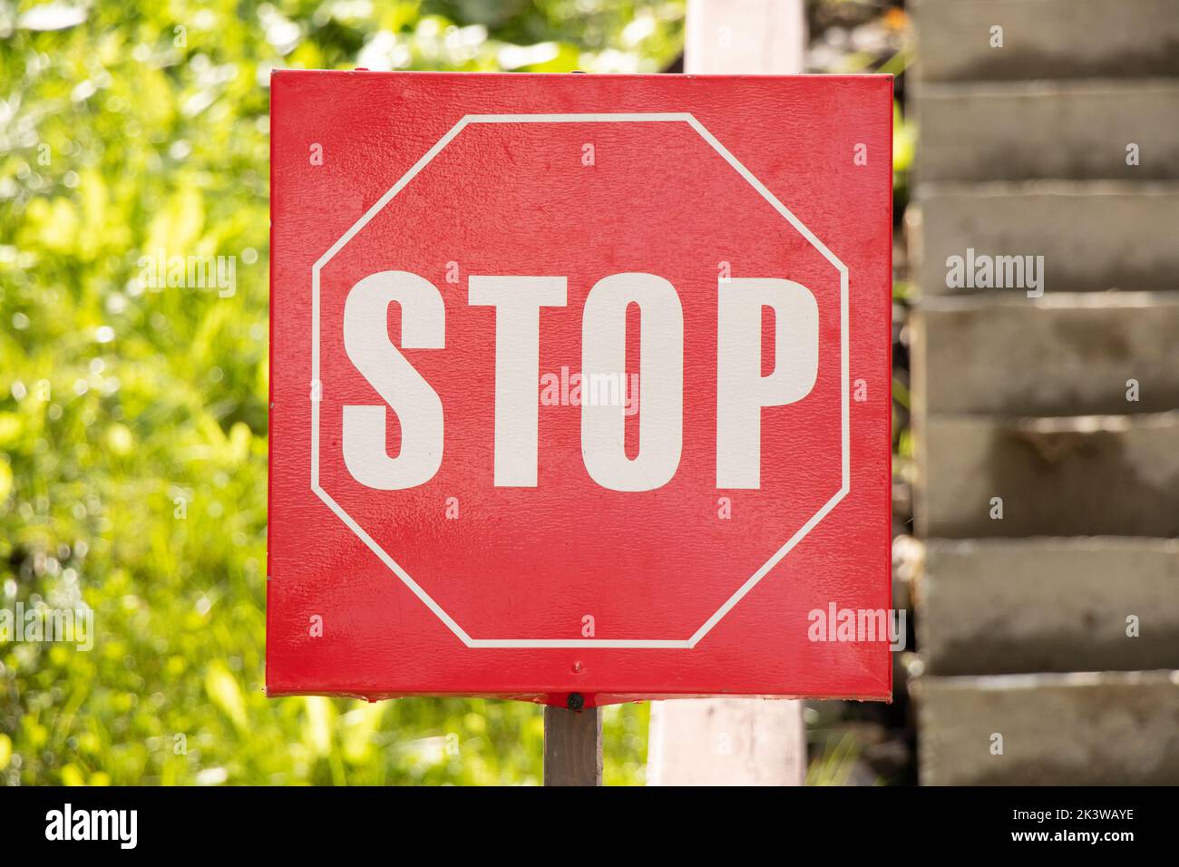 Stop sign on a red plate near the entrance to the park close-up Stock ...