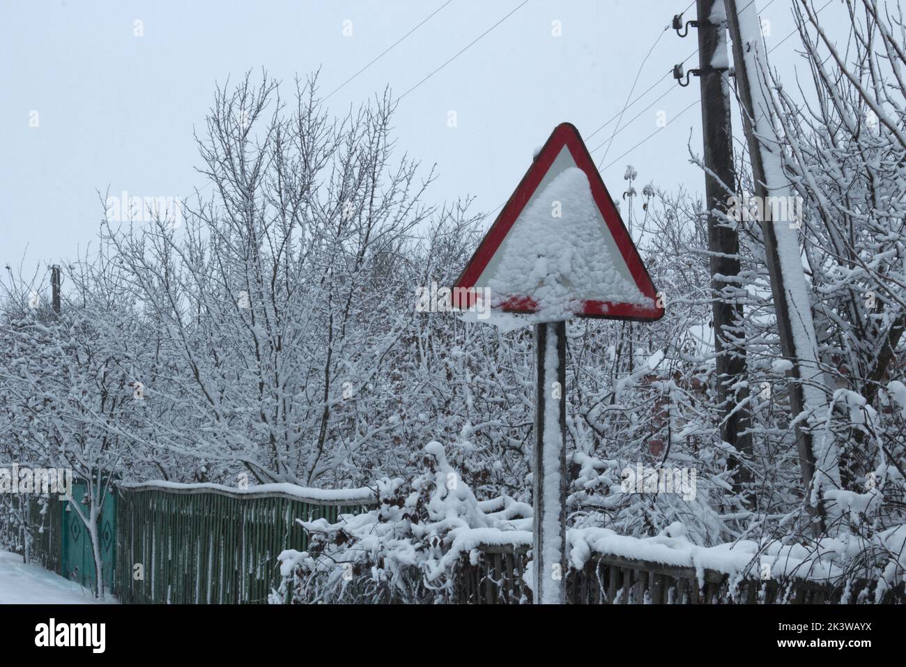 Snow covered road sign and trees. Road sign covered with snow Stock ...
