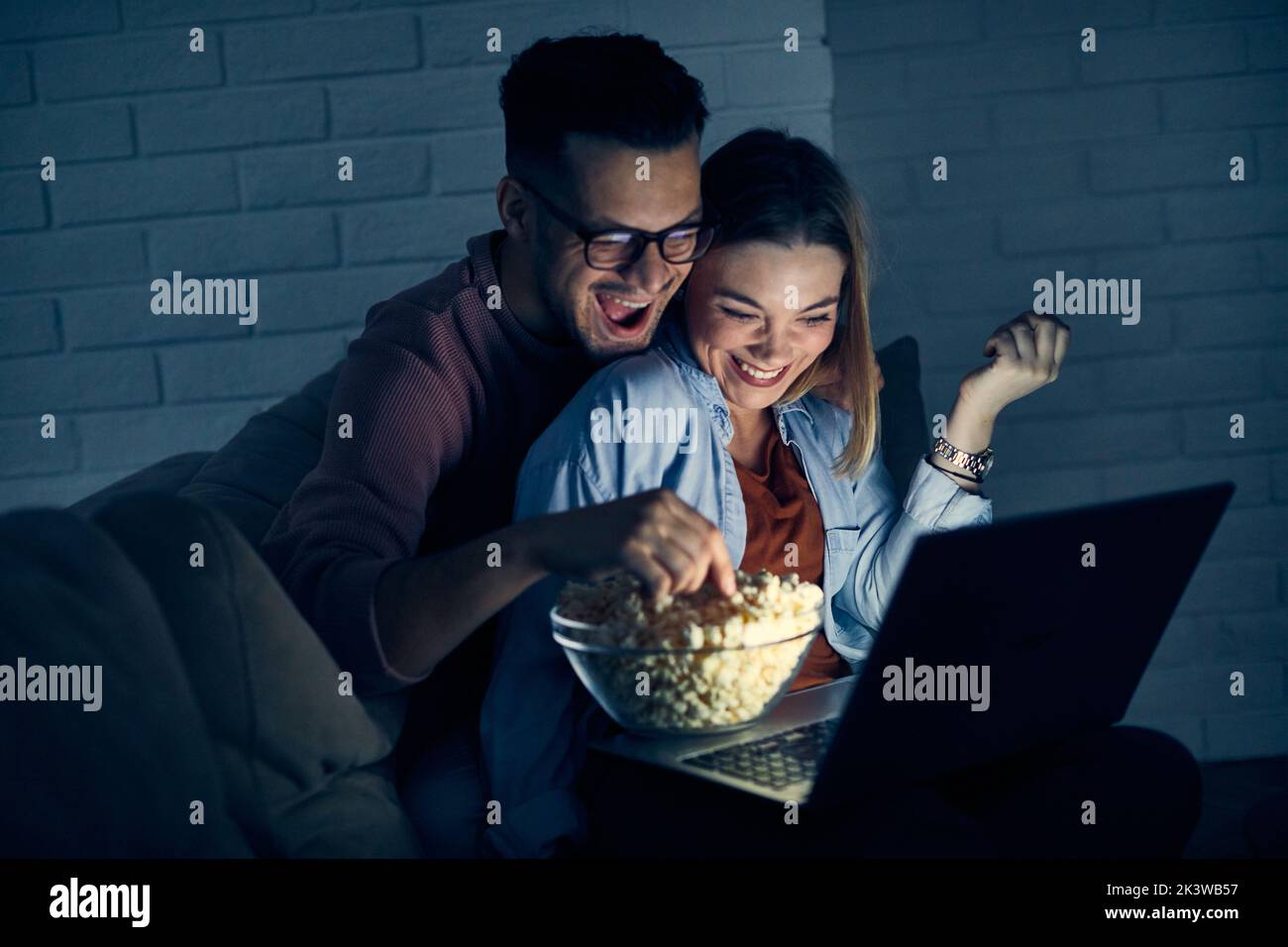 Couple having movie night at home Stock Photo - Alamy