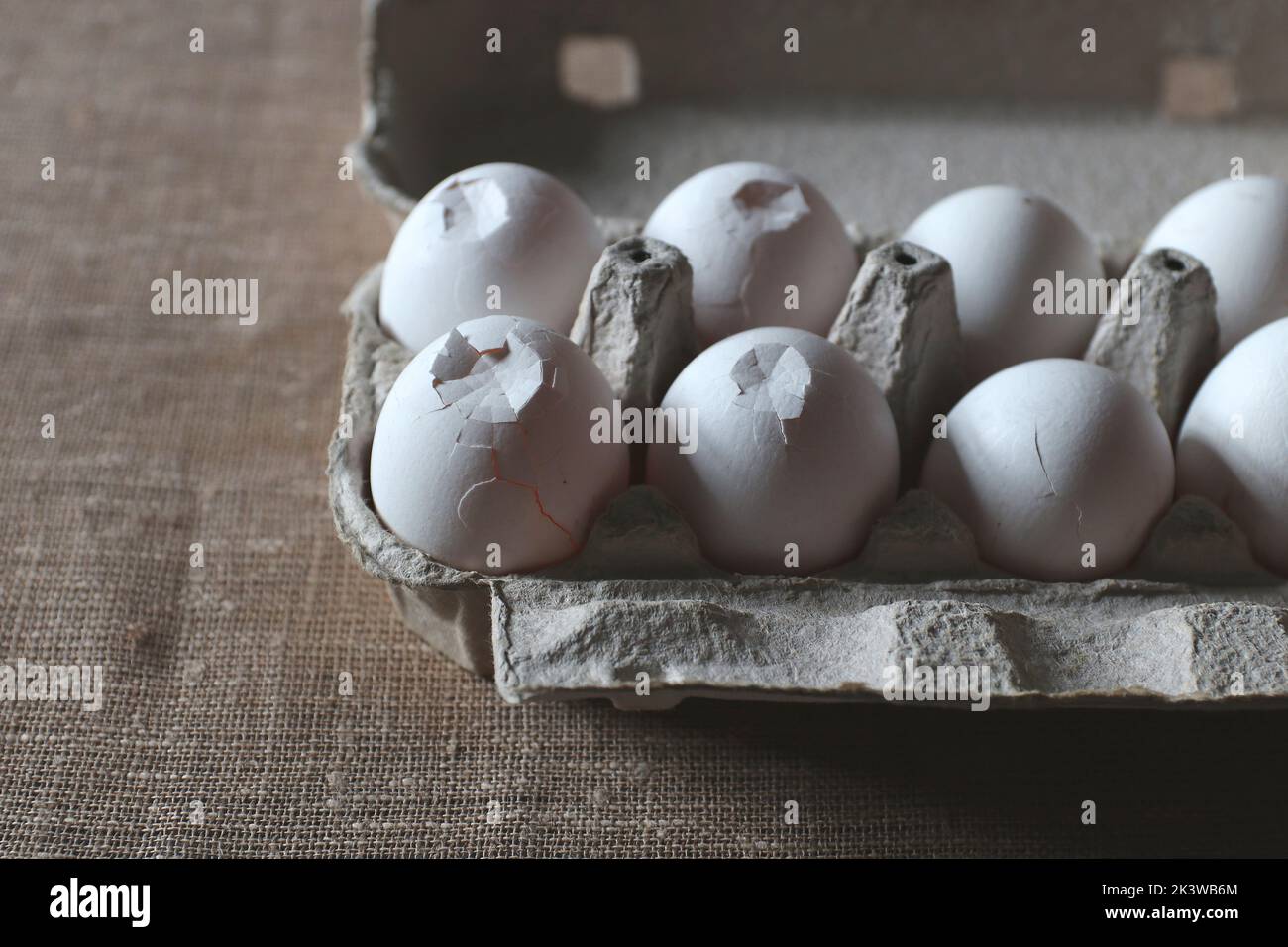 Eggs with cracked egg shell in egg carton container. Concept for easter ...