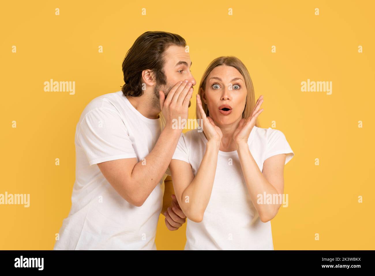 Man whispering in woman ear hi-res stock photography and images - Alamy