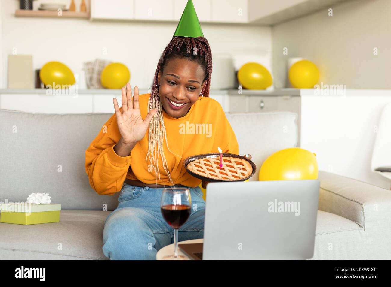 Remote birthday party. Happy african american lady holding pie and ...