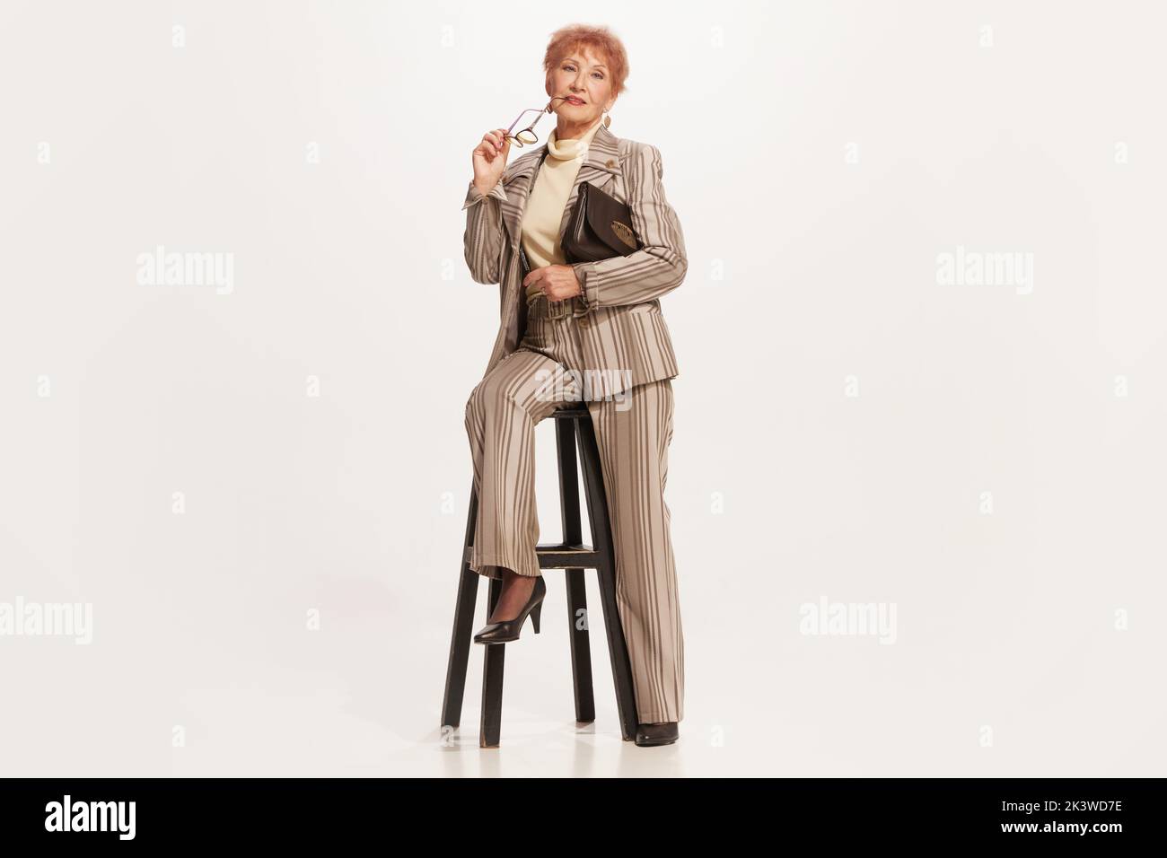 Portrait of beautiful senior woman in retro vintage style outfit posing ...