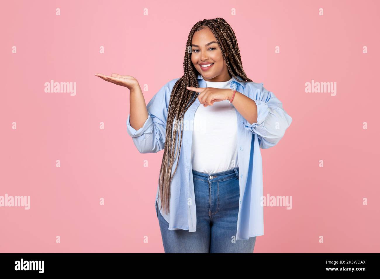 Cheerful African American Plump Lady Pointing Finger Aside, Pink ...