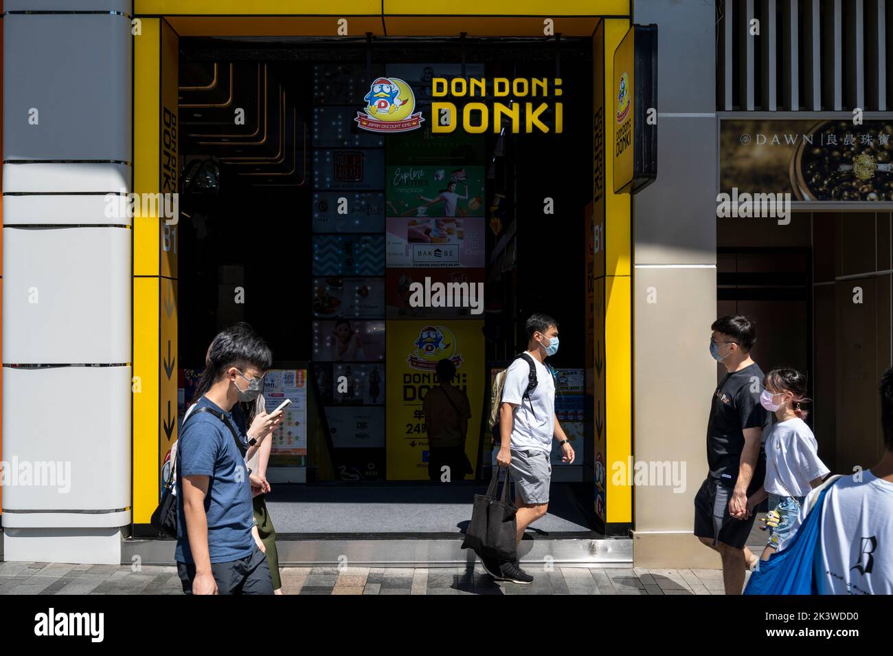 Pedestrians walk past Japan's largest chain stores company Don Quijote ...