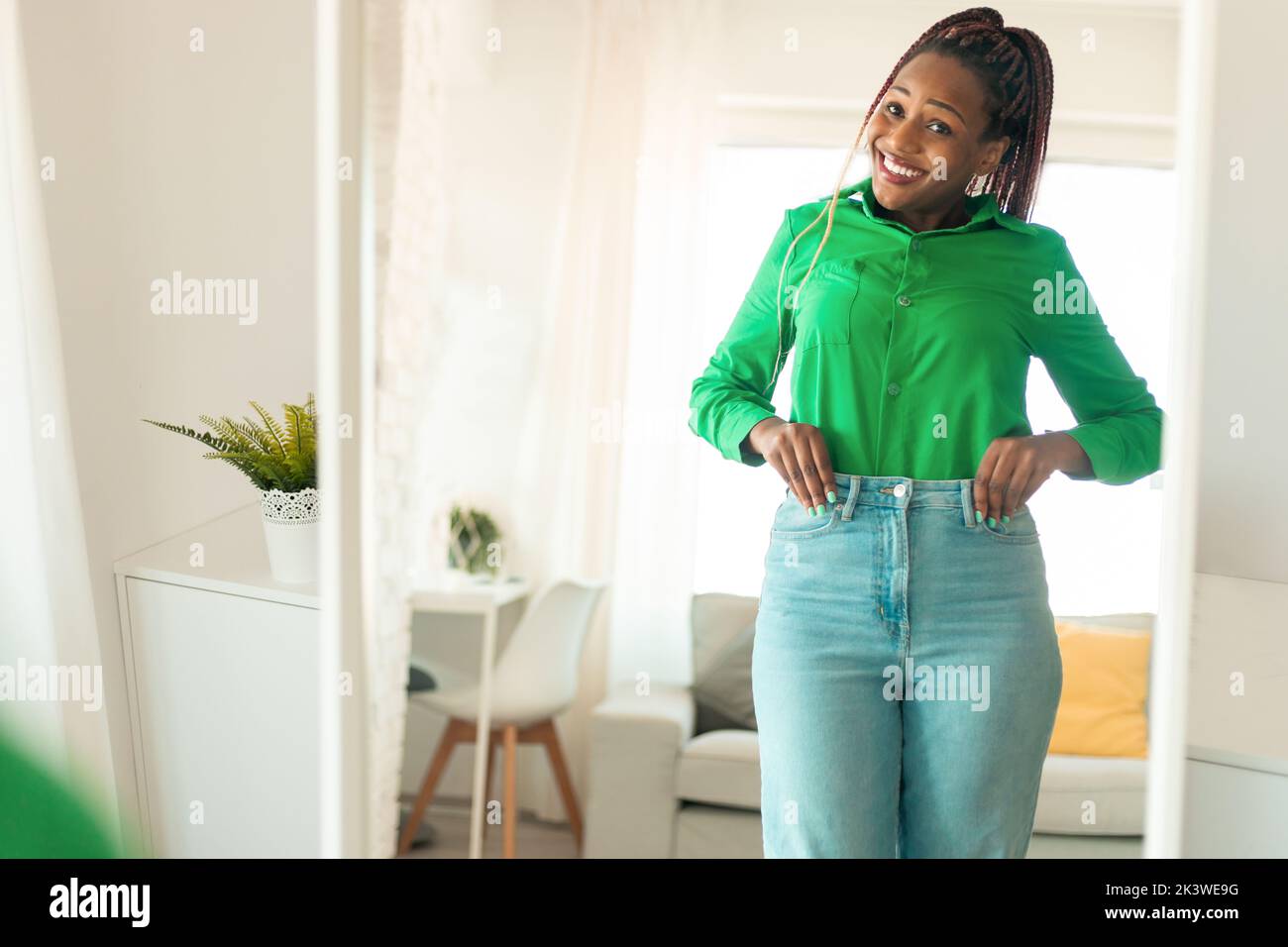 Female beauty and self-confidence. Positive black woman posing near ...