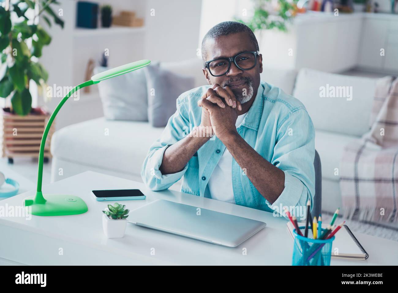 Portrait of handsome smart businessman working from home using wireless ...