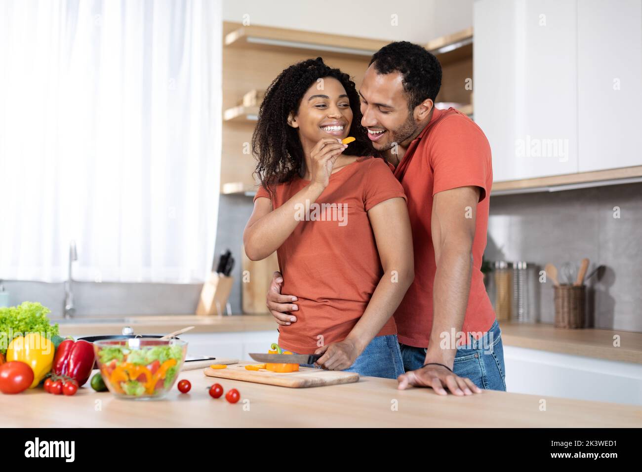 Cheerful Millennial Black Husband Hugging Lady Woman Cutting Organic
