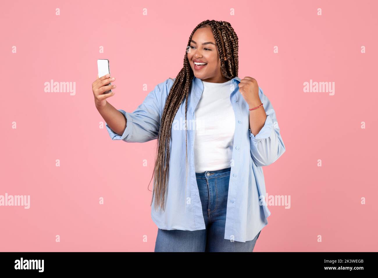 African American Lady Video Calling Holding Smartphone Over Pink ...