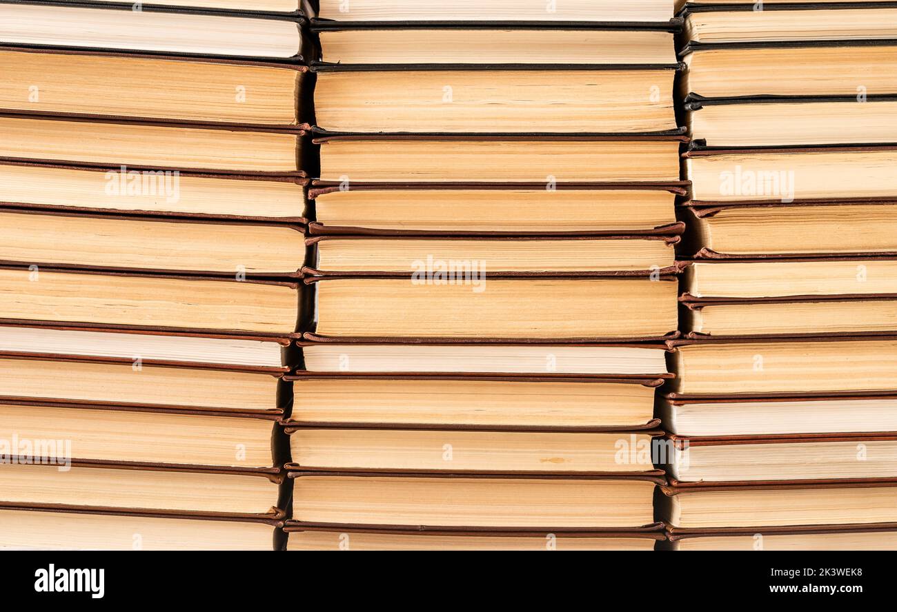 Pile towers of many books, old literature heap. Paper textbooks ...