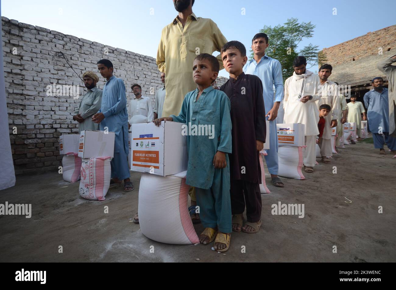 Peshawar, Pakistan. 22nd Sep, 2022. People affected by floods receive ...