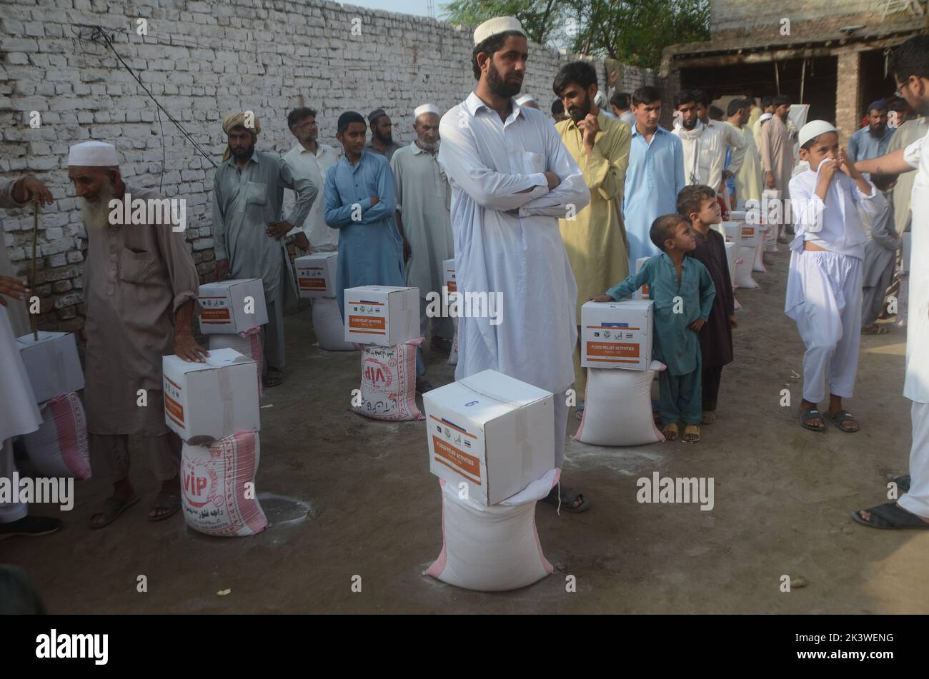 Peshawar, Pakistan. 22nd Sep, 2022. People affected by floods receive ...
