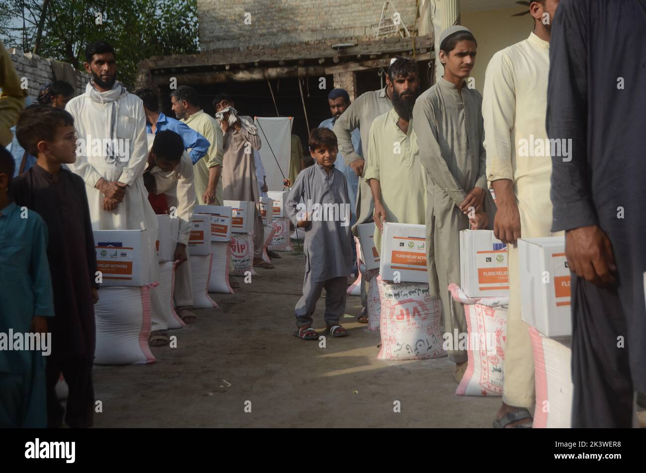 Peshawar, Pakistan. 22nd Sep, 2022. People affected by floods receive ...