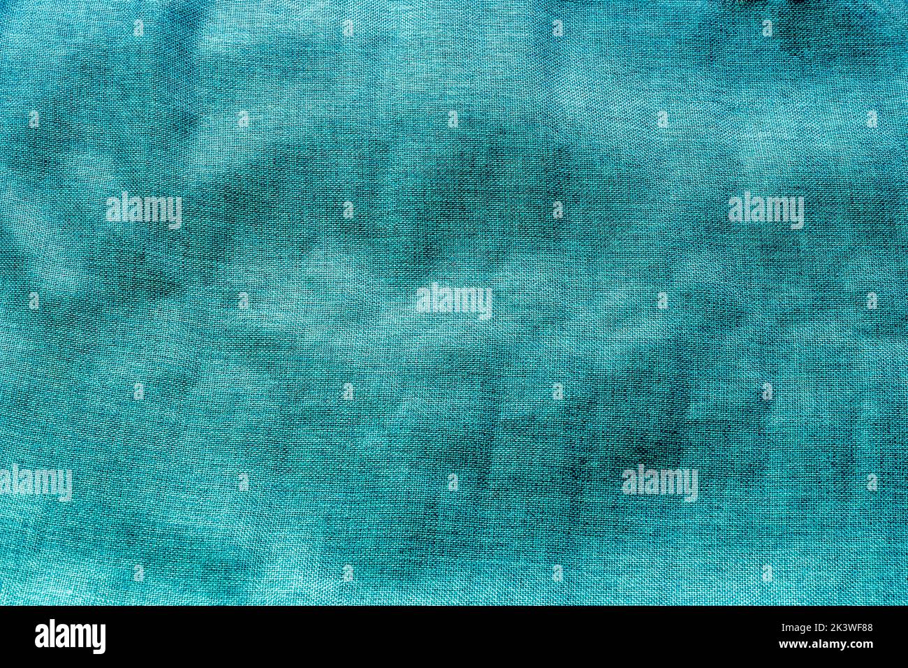 Turquoise blue fabric background with visible pattern and some wrinkles ...