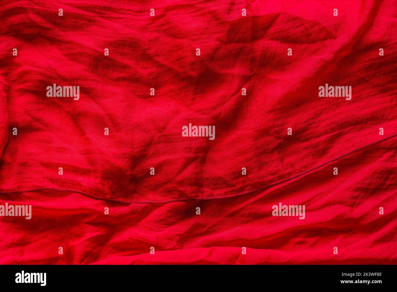 Subtle light red cloth fabric background with visible pattern and some ...