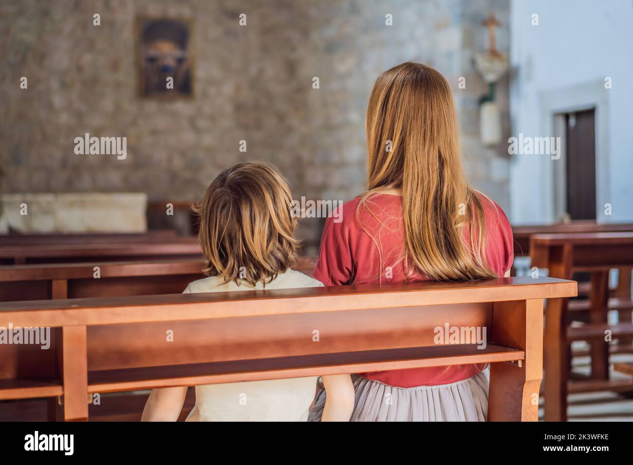 A Christian mom tells her son Bible stories about Jesus sitting in ...